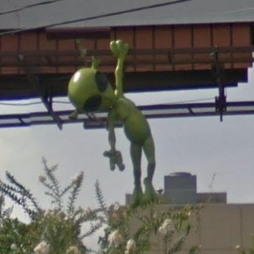 Alien hanging from billboard in Tallahassee, FL (Google Maps)