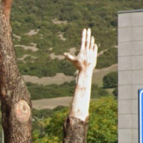 Hand sculpture out of a dead tree in Allai, Italy - Virtual Globetrotting